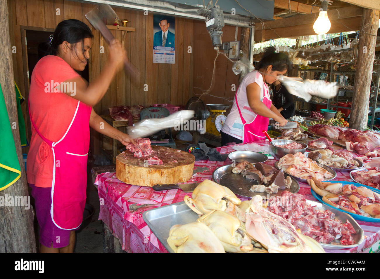 Women chopping and selling meat at an open air market on the island of ...