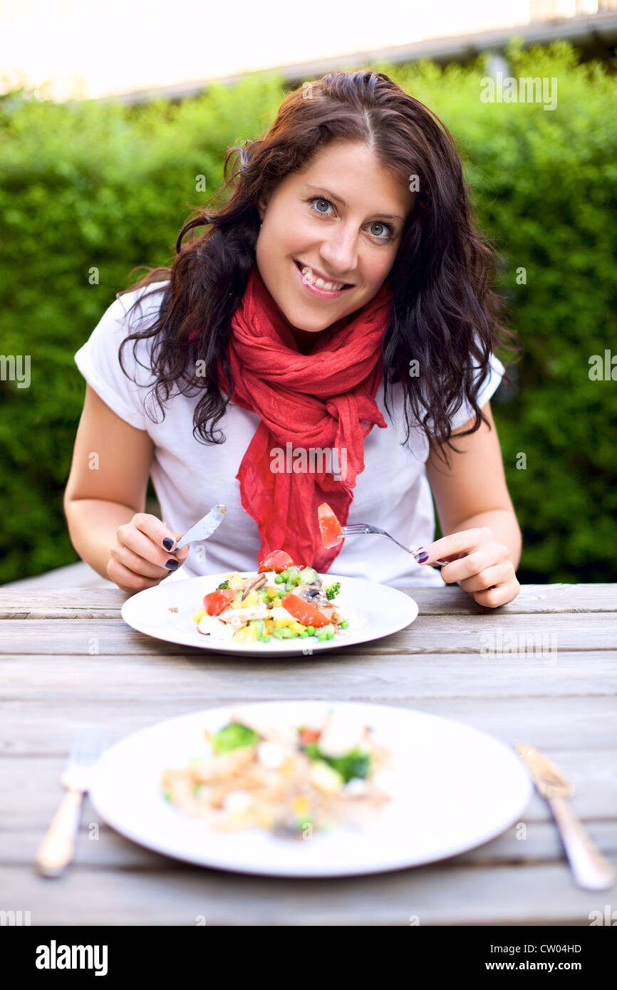 Portrait of an attractive woman eating on a sidewalk cafe Stock Photo ...