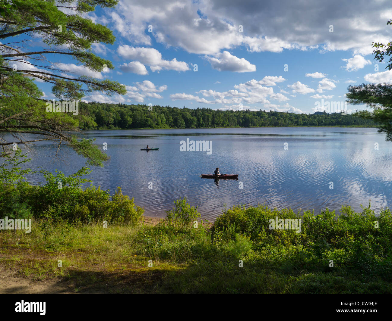 Kayakers on Upper Pond near town of Inlet in the Adirondack Mountains ...