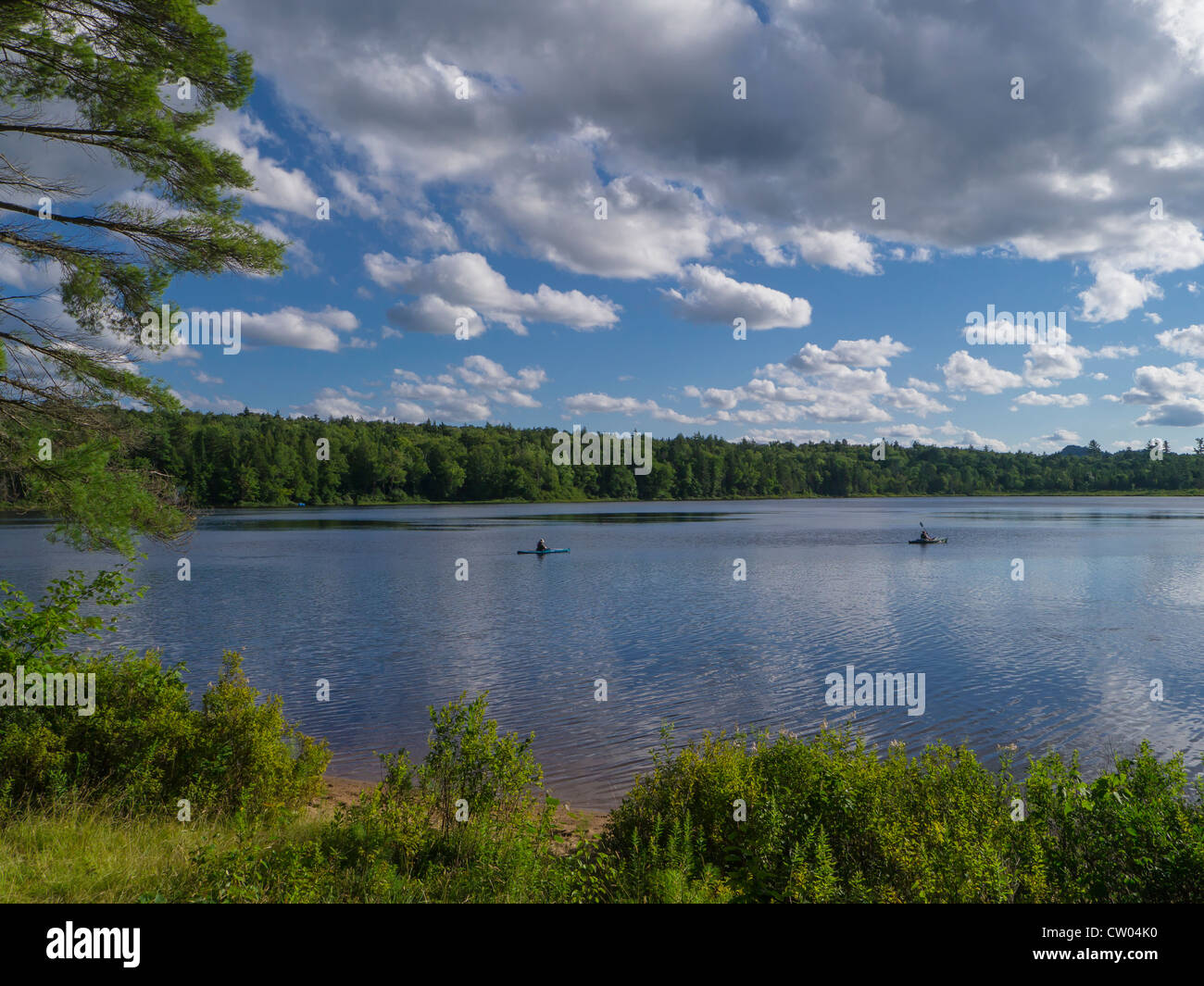 Kayakers on Upper Pond near town of Inlet in the Adirondack Mountains ...
