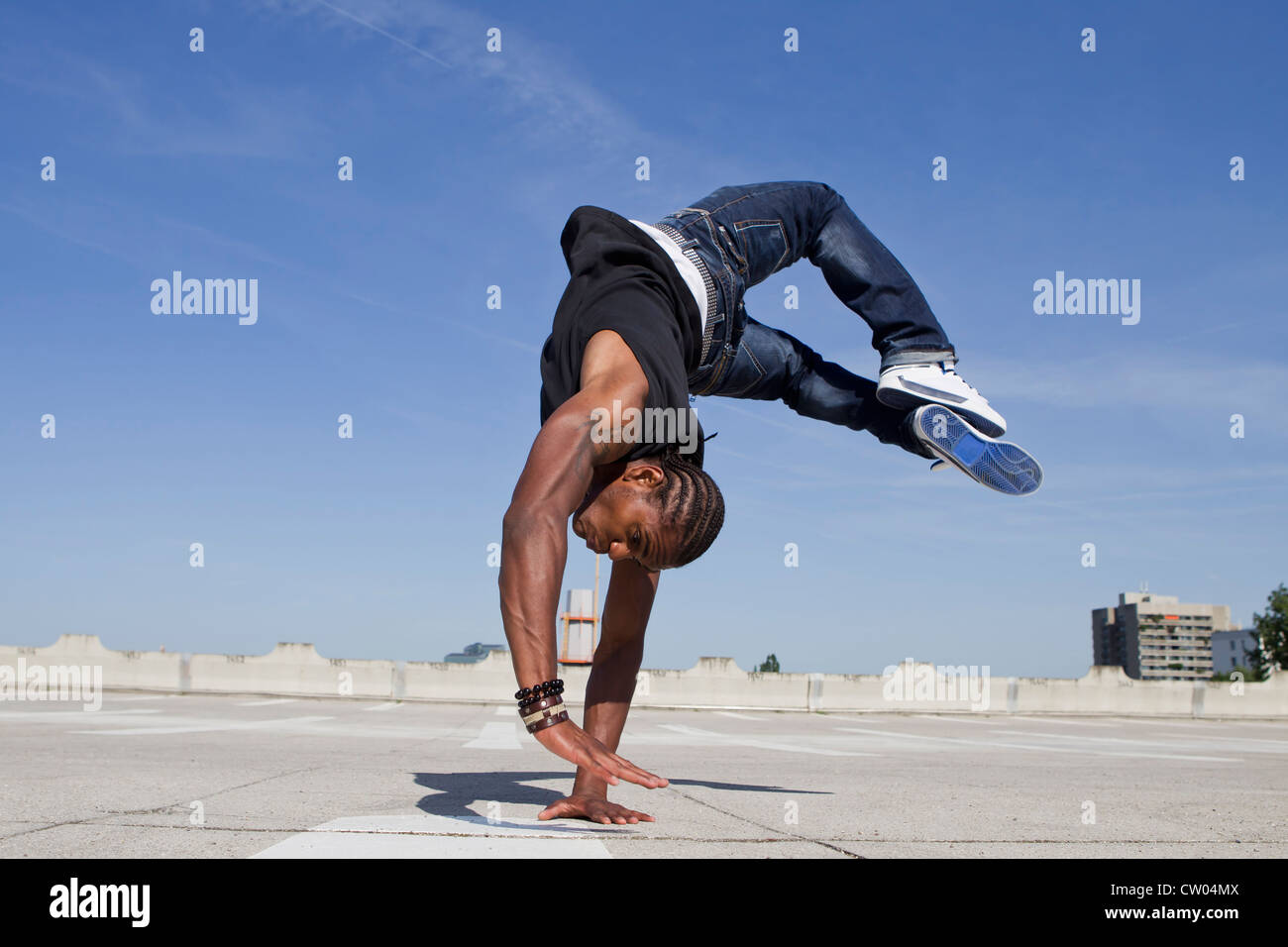 Man doing handstand on rooftop Stock Photo - Alamy