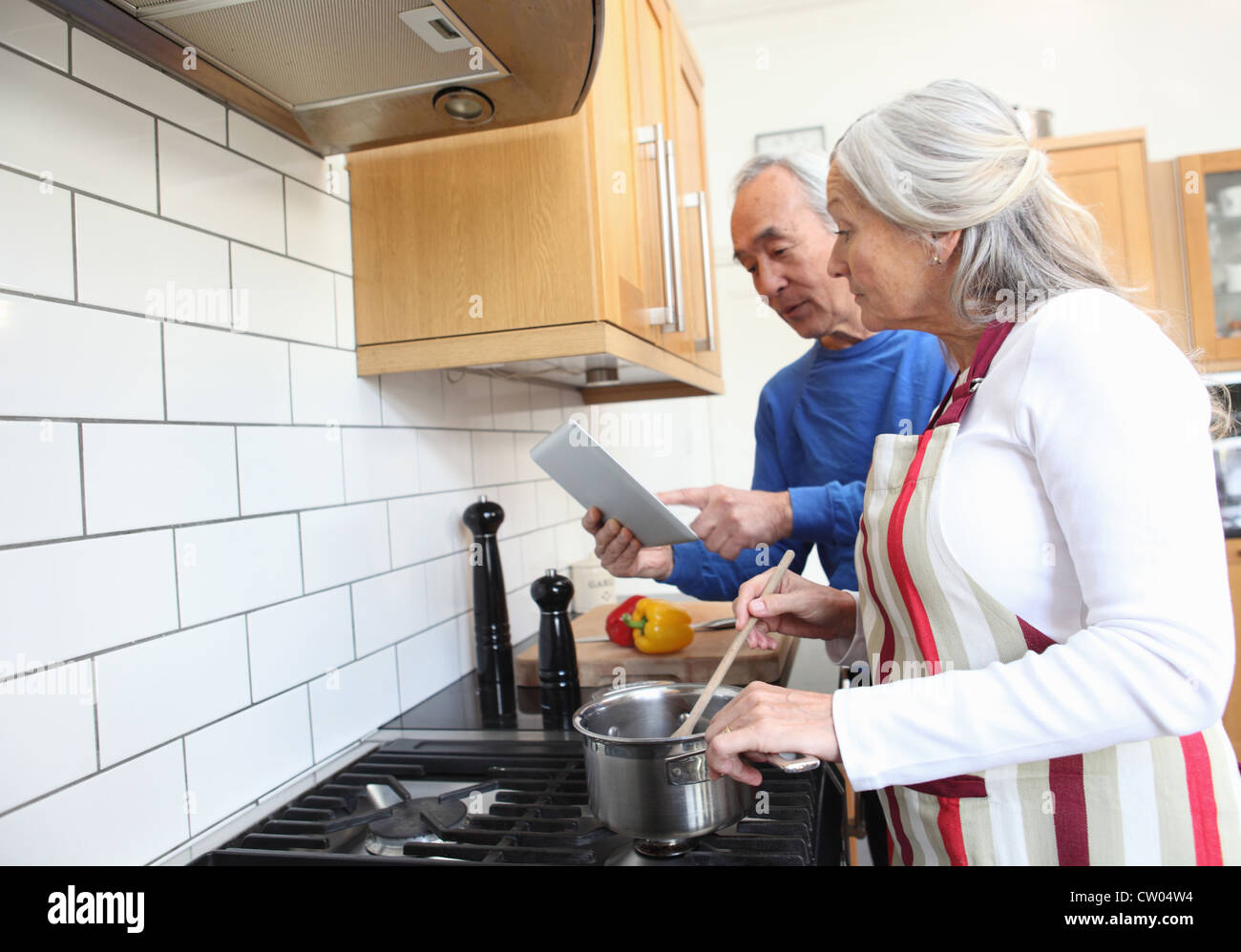 Older couple cooking together in kitchen Stock Photo - Alamy