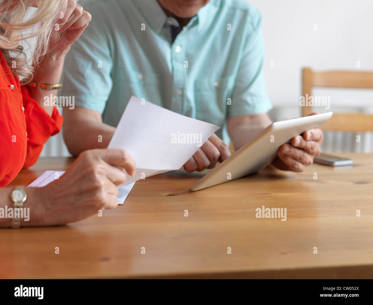 Older couple reading mail in kitchen Stock Photo - Alamy