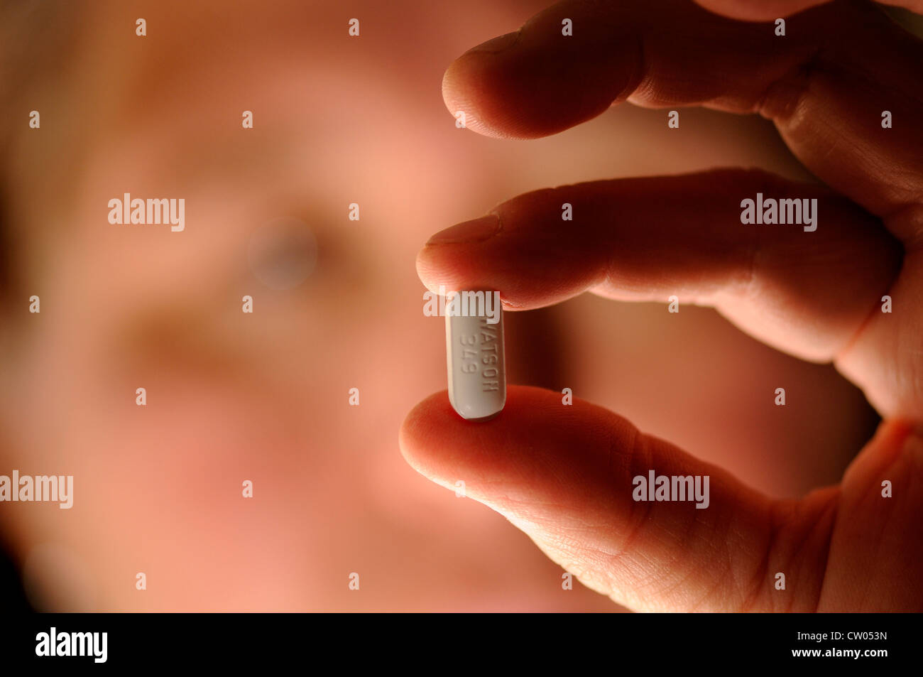 A patient with polycystic kidney disease holds a Vicodin 5/500 m tab ...