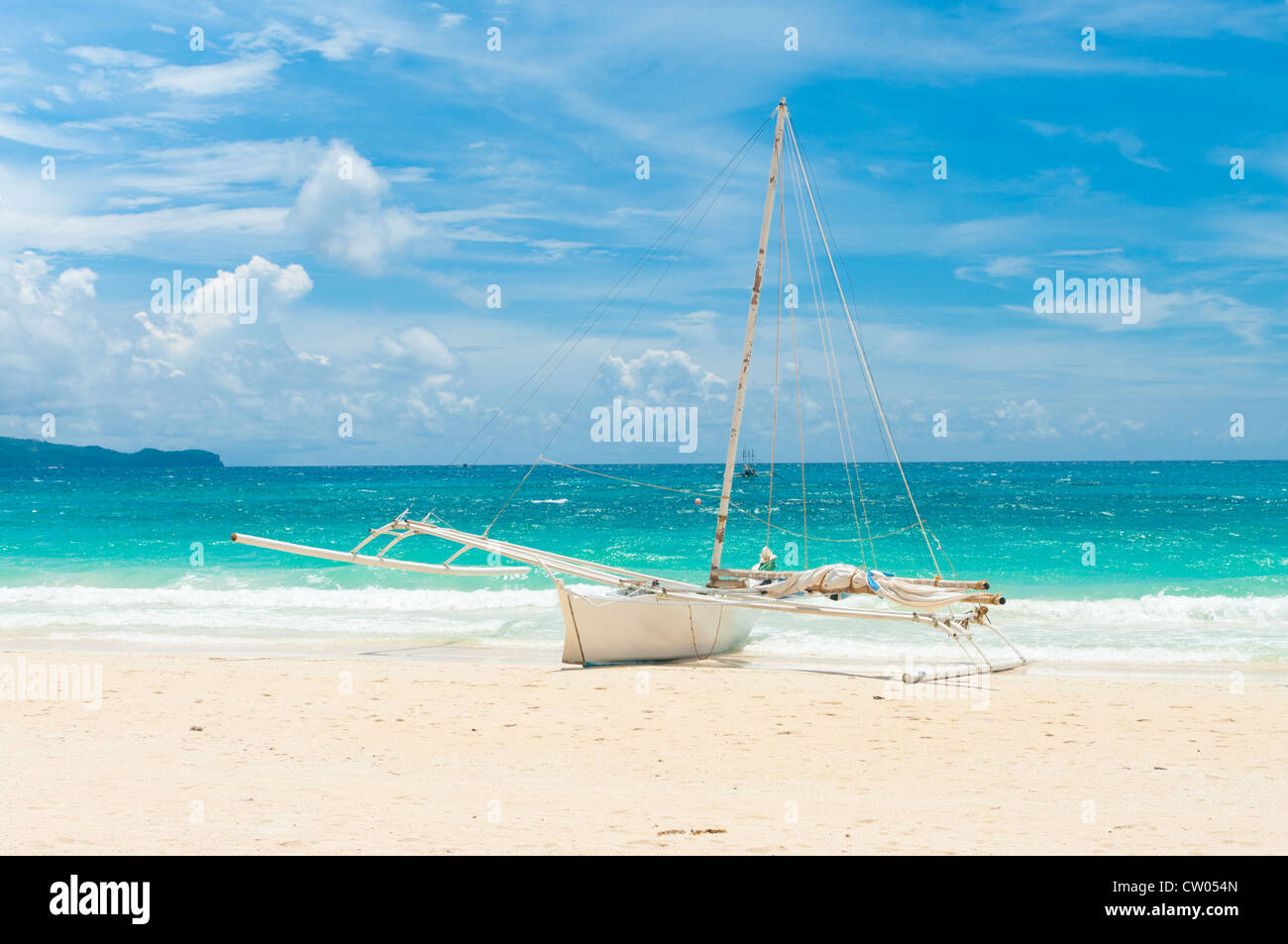 traditional paraw sailing boat on white beach on boracay island ...