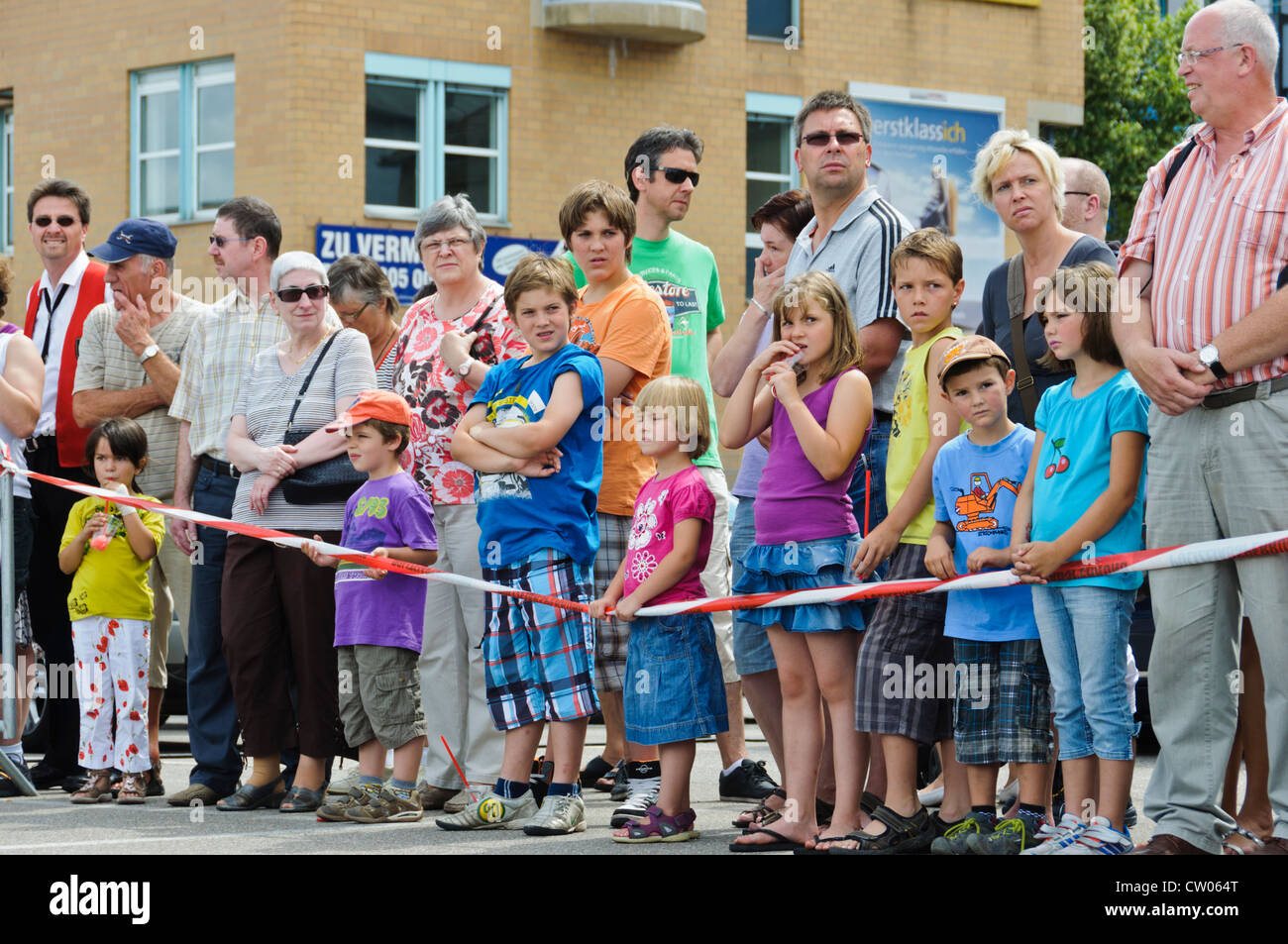Group of spectators gaper including adults, children, men, women, boys ...