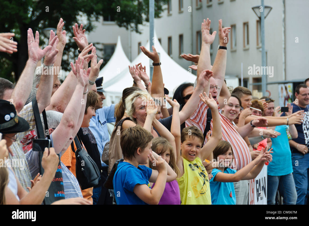Cheering crowd yelling and performing Mexican Wave (Laola Welle) hands ...