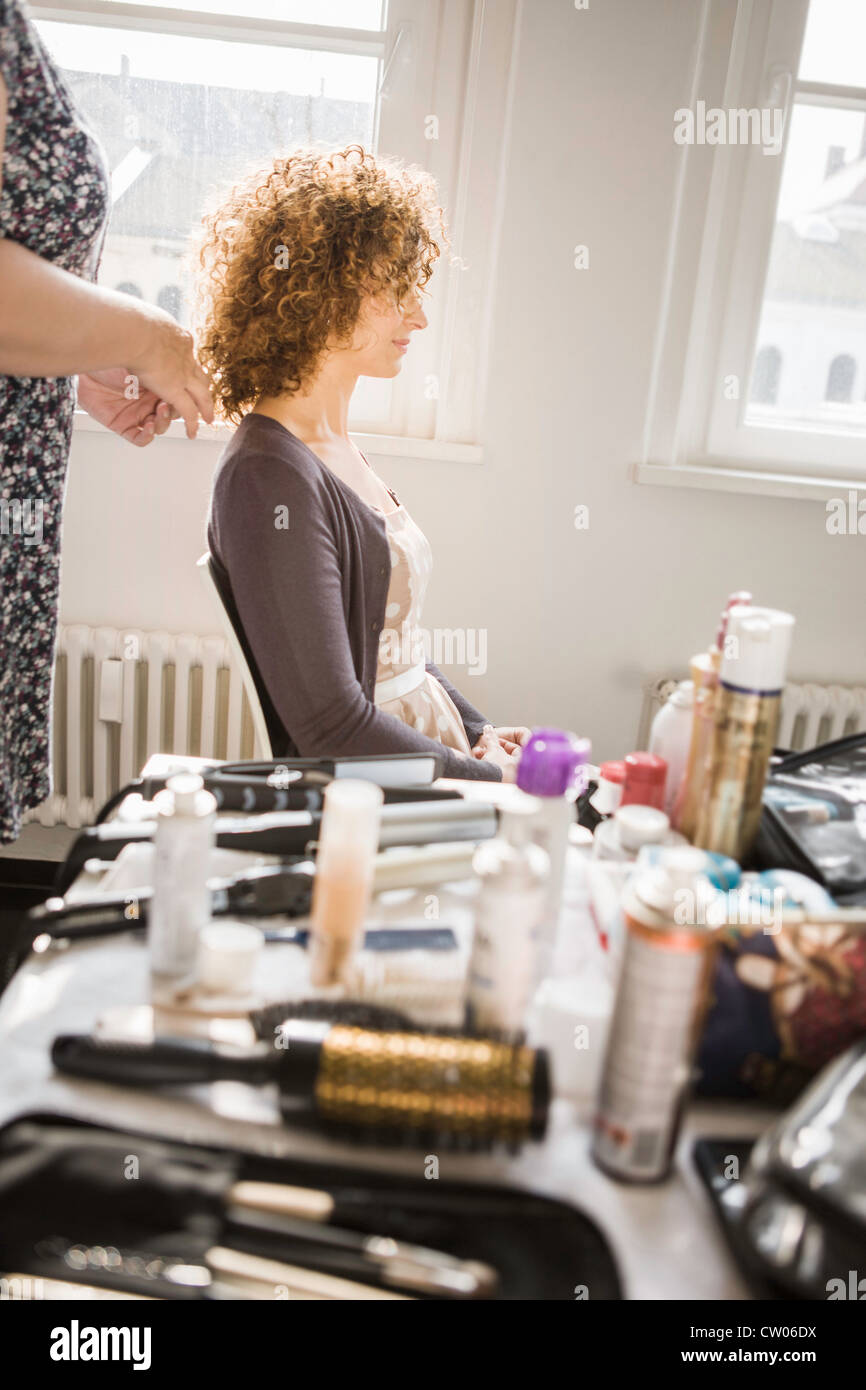 Hair stylist working on client Stock Photo - Alamy