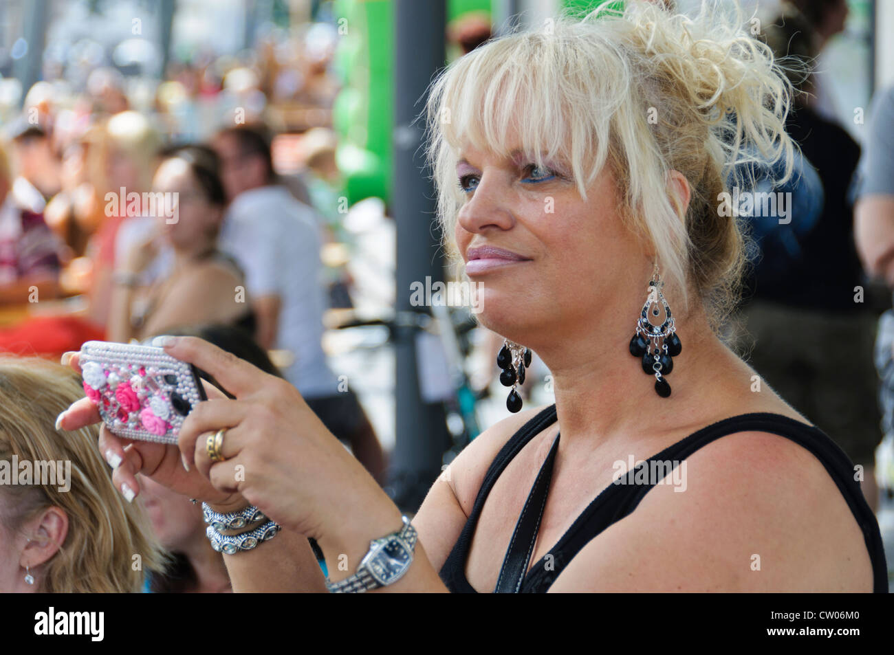 Caucasian adult pneumatic blond woman with eye-catching makeup takes ...