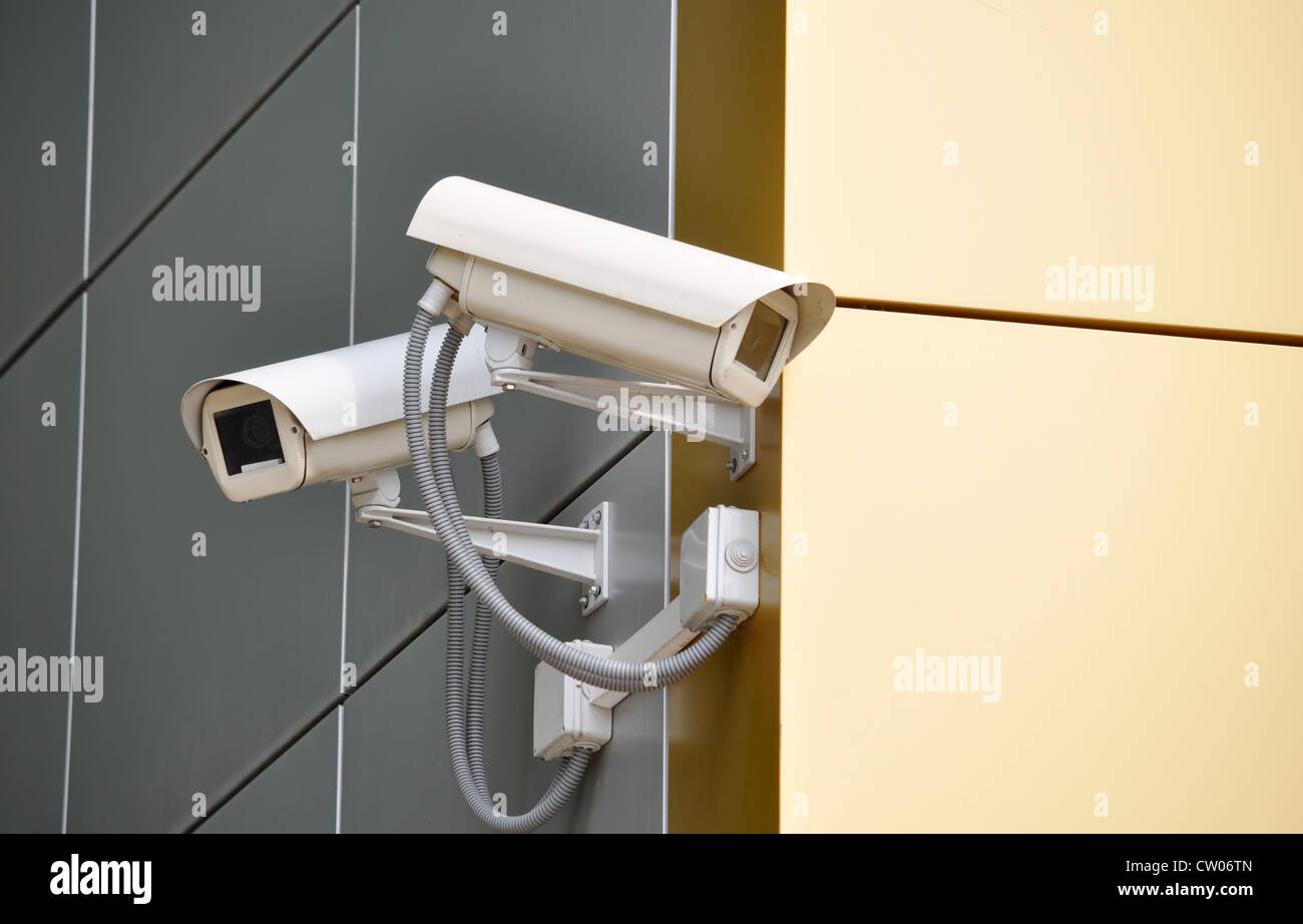 Two CCTV cameras on the cone of the morden building Stock Photo - Alamy