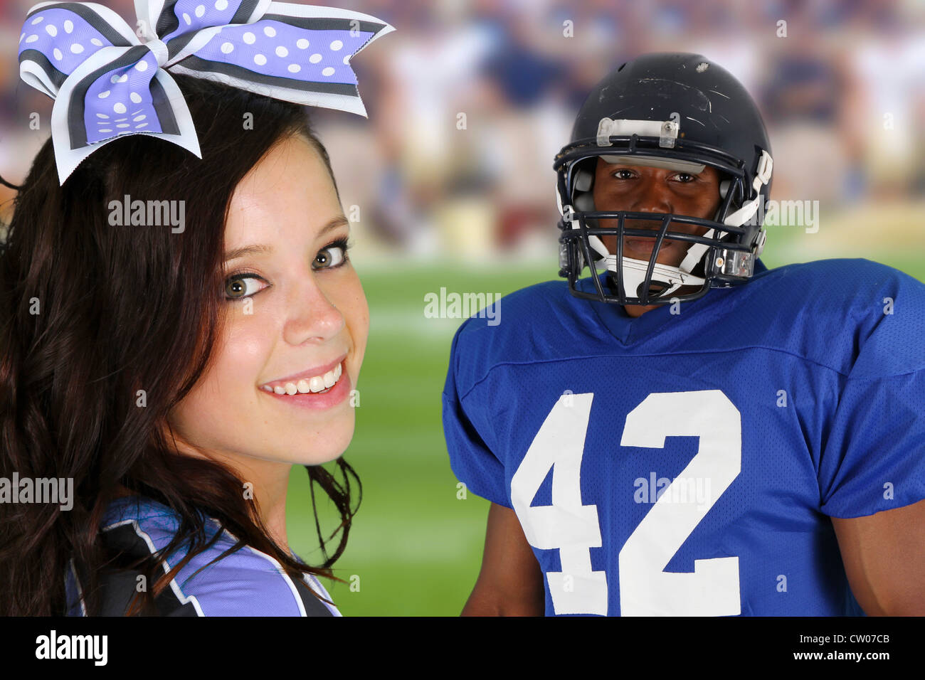 Teenage cheerleader with a football player on the field Stock Photo - Alamy