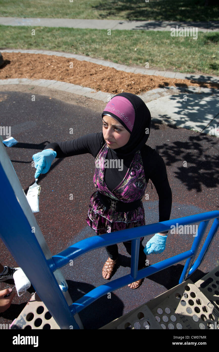 Volunteers paint playground equipment in Detroit's Romanowski Park ...