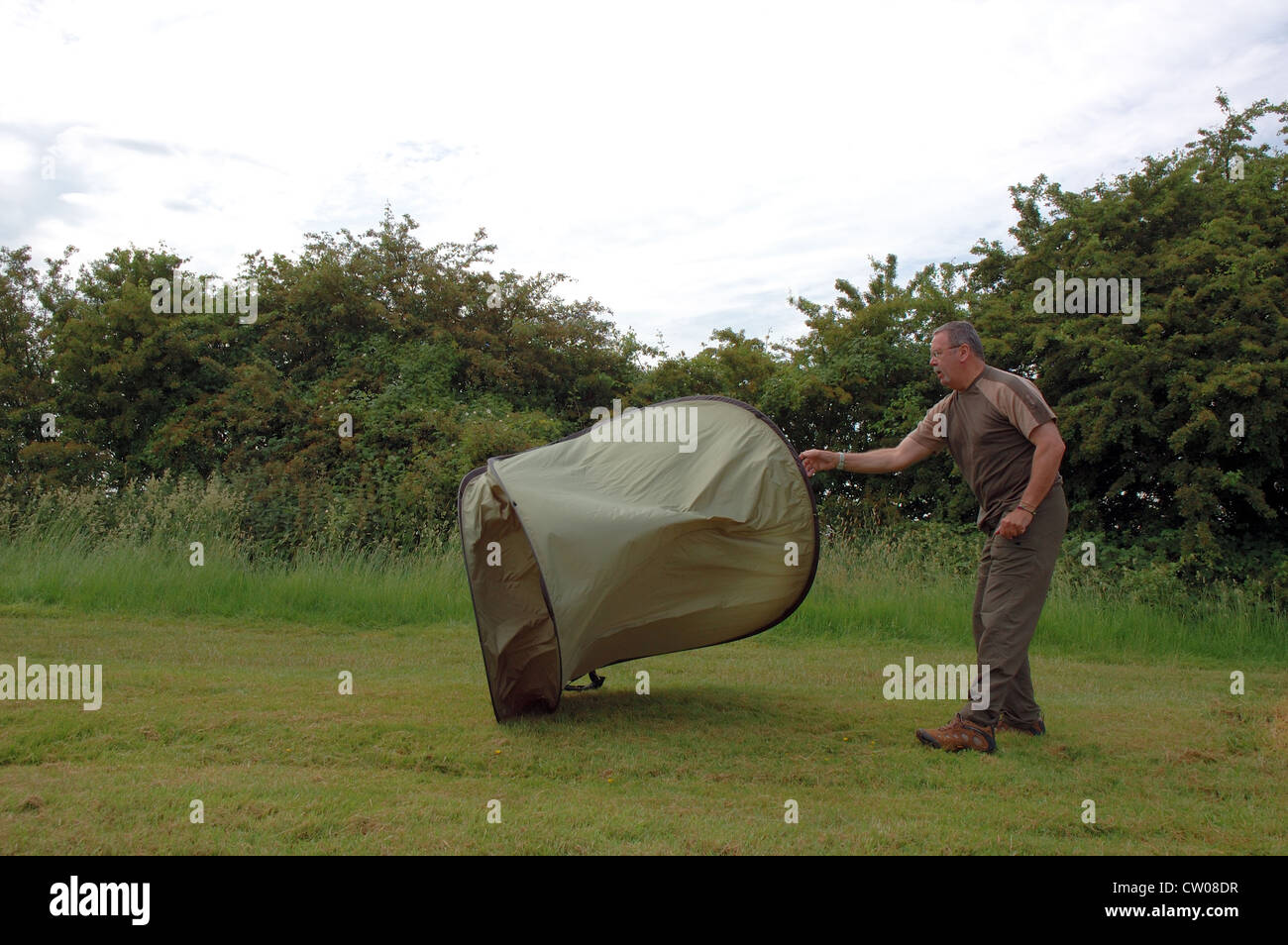 Man throwing pop-up tent into the air - 4 of a series of 5 Stock Photo ...