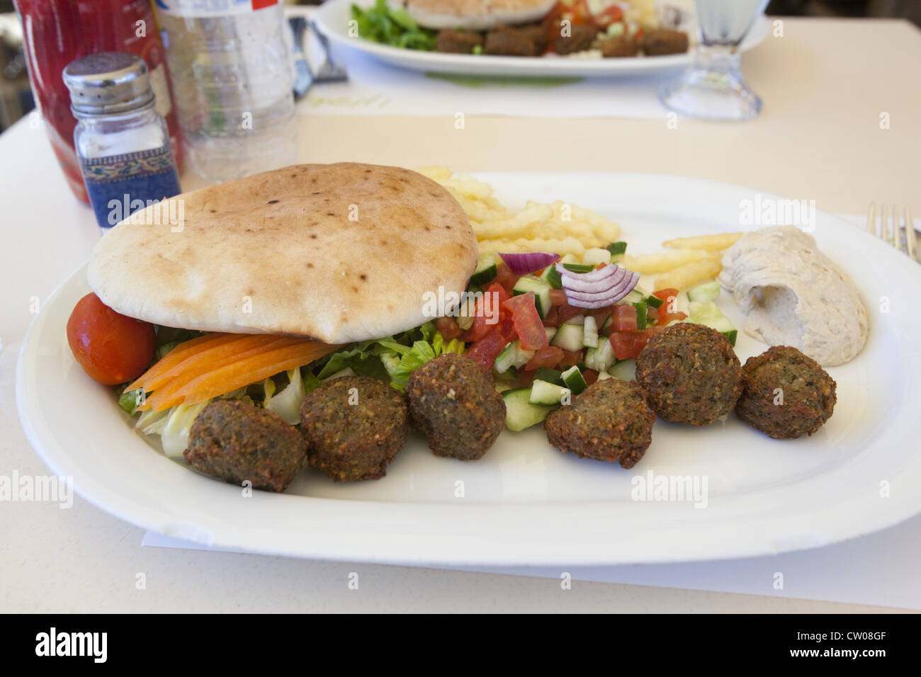 Lunch consisting of deep-fried falafel balls, salad, French-fries ...