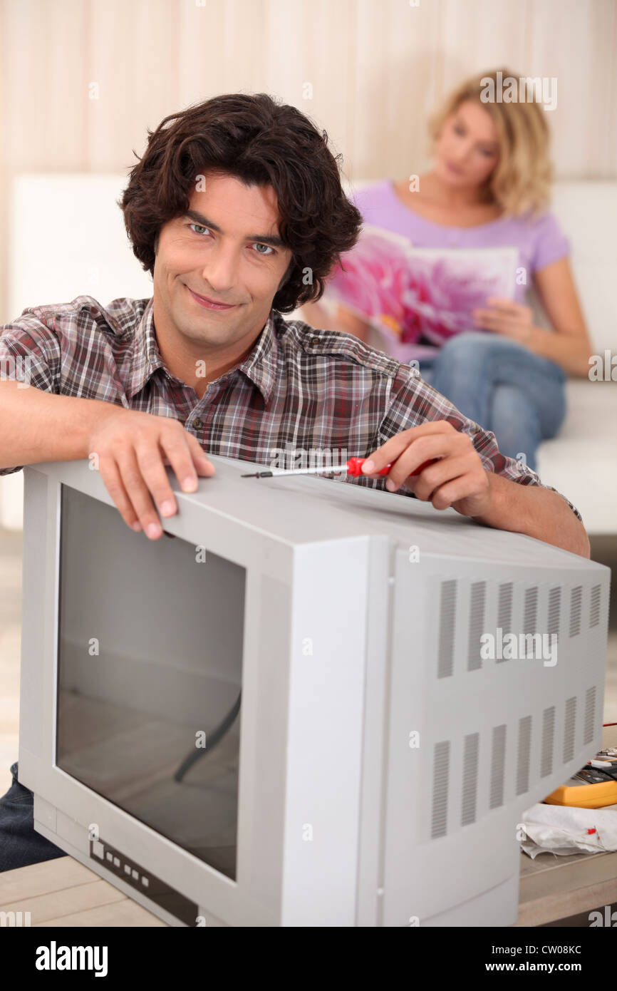 Man fixing an old television Stock Photo - Alamy
