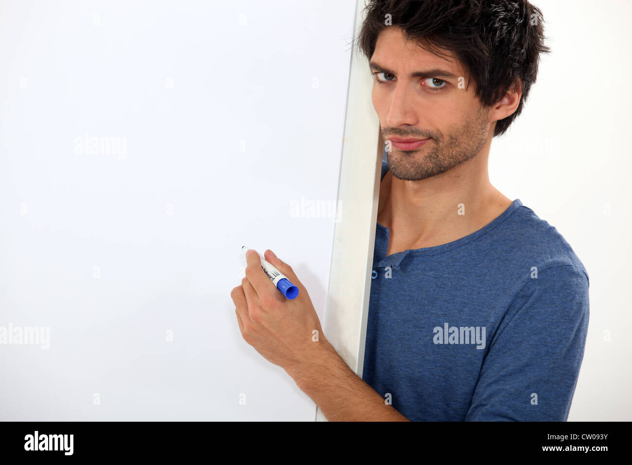 Confused man writing on a whiteboard Stock Photo - Alamy