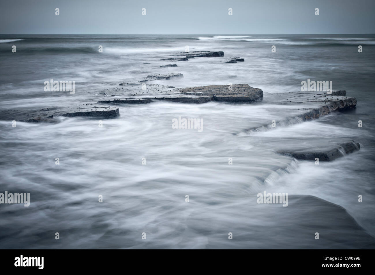 Waves washing over the rocks Stock Photo - Alamy