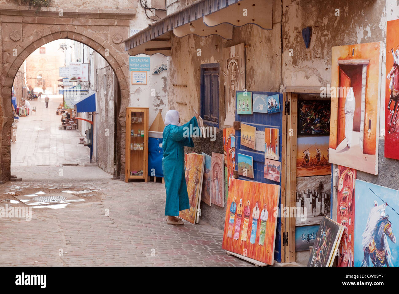 Shopkeeper puts out her goods in the souk (market), the medina ...