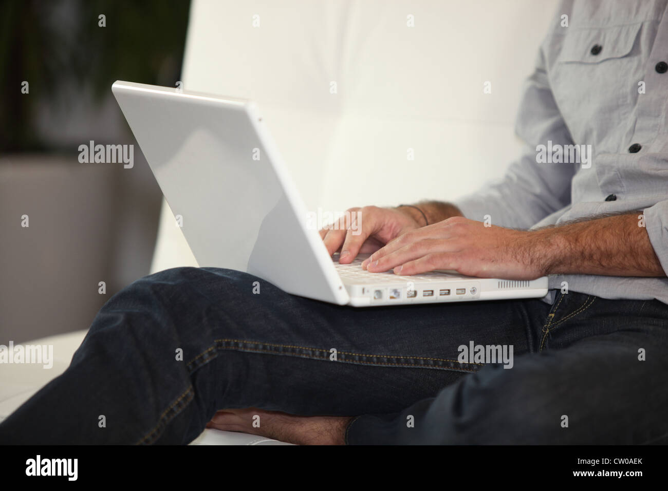 Man typing on a laptop Stock Photo - Alamy