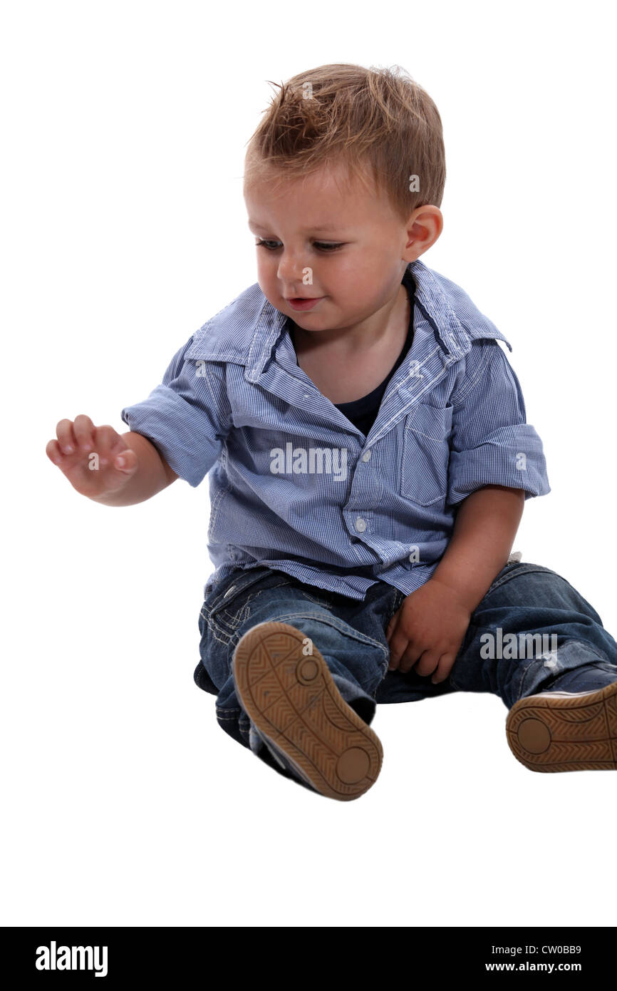 Little boy looking at his hand Stock Photo - Alamy