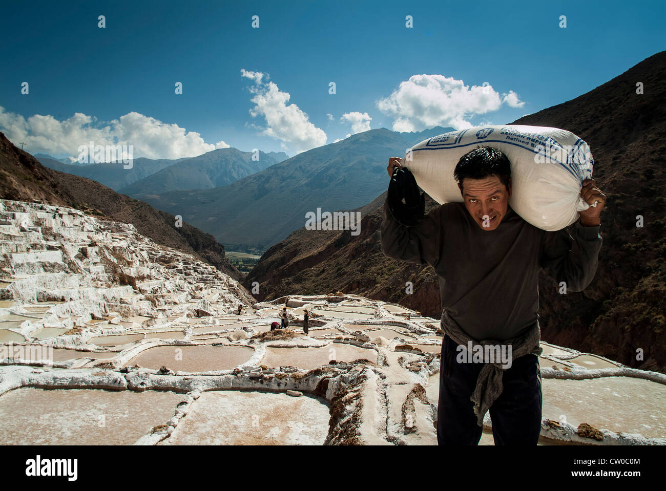 Worker mining salt at Inca Salt mine at Maras in the Urubamba Valley ...