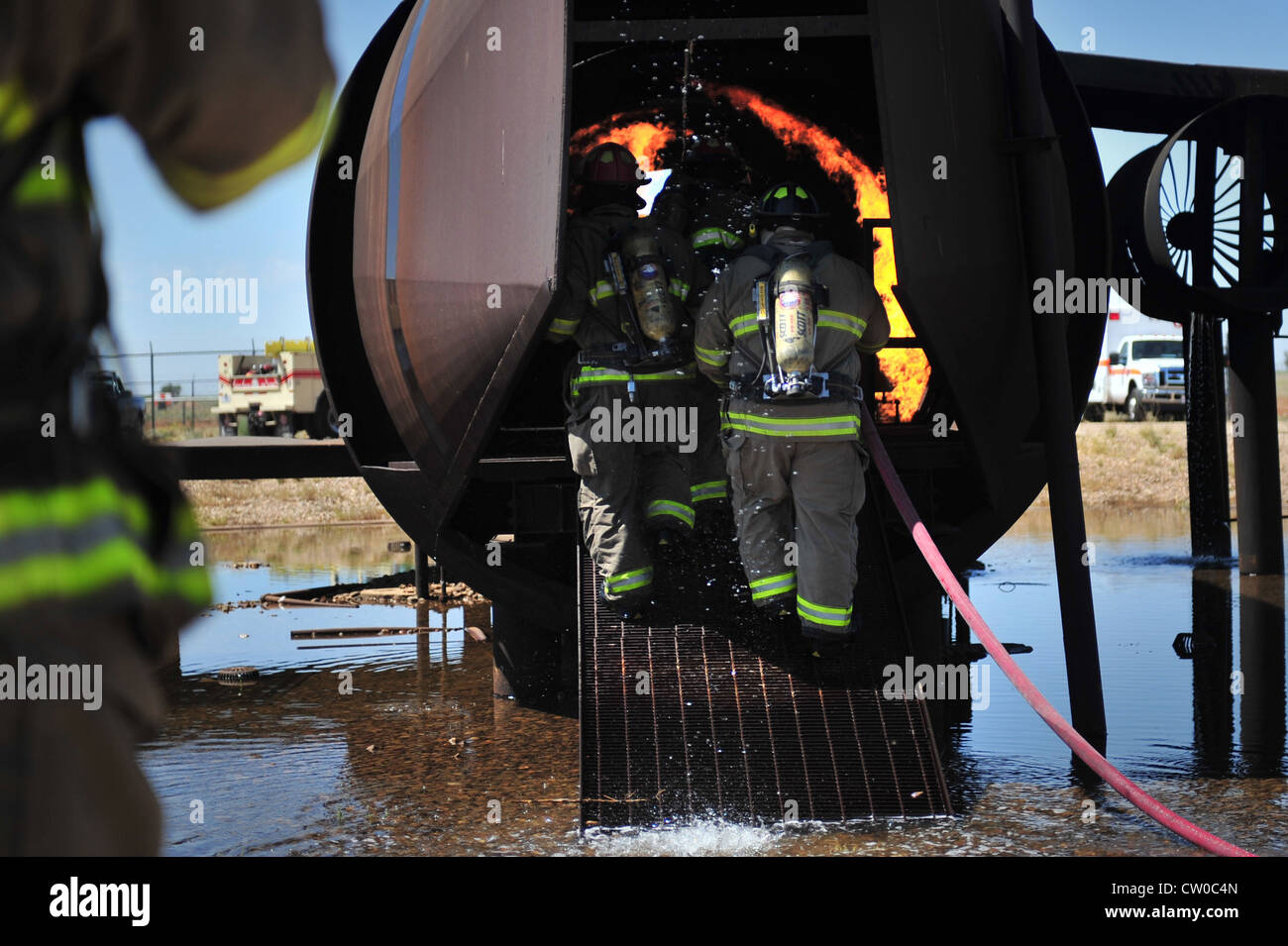 Firefighters with the Clovis, N.M. Fire Department enter the burn pit ...