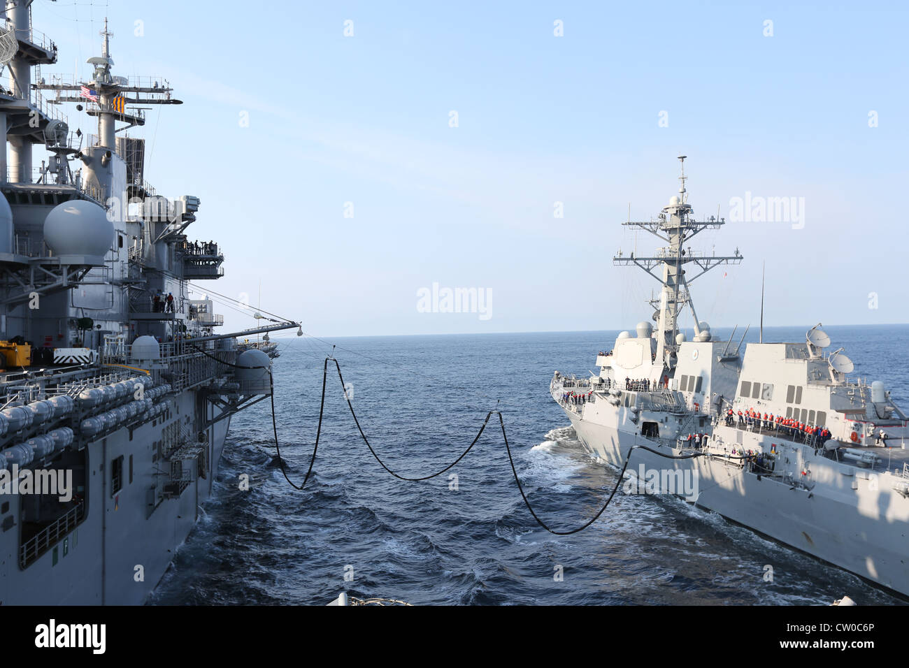 The guided-missile destroyer USS Gravely (DDG 107) receives fuel from ...