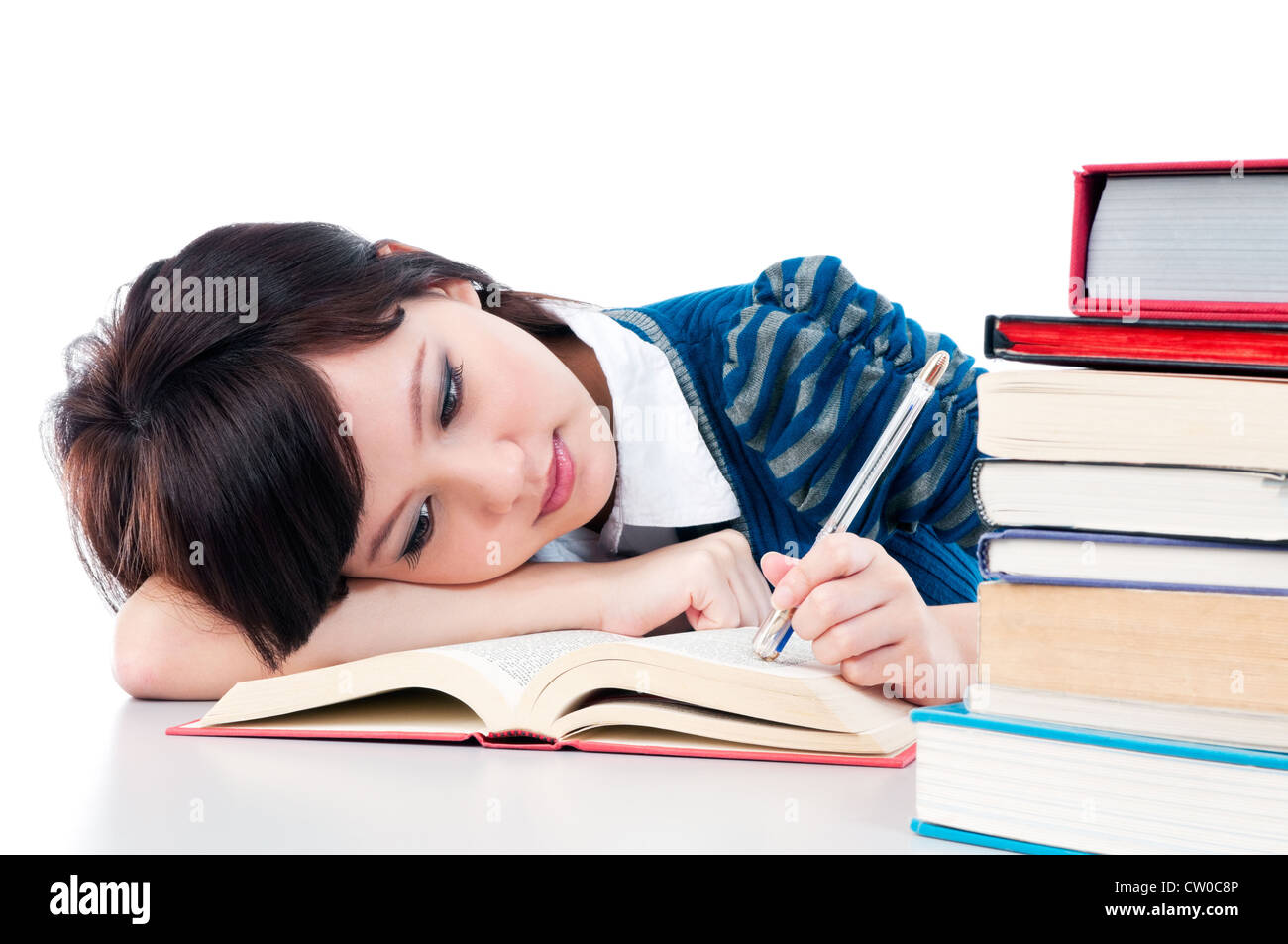 Tired student resting on her arm while reading book Stock Photo - Alamy