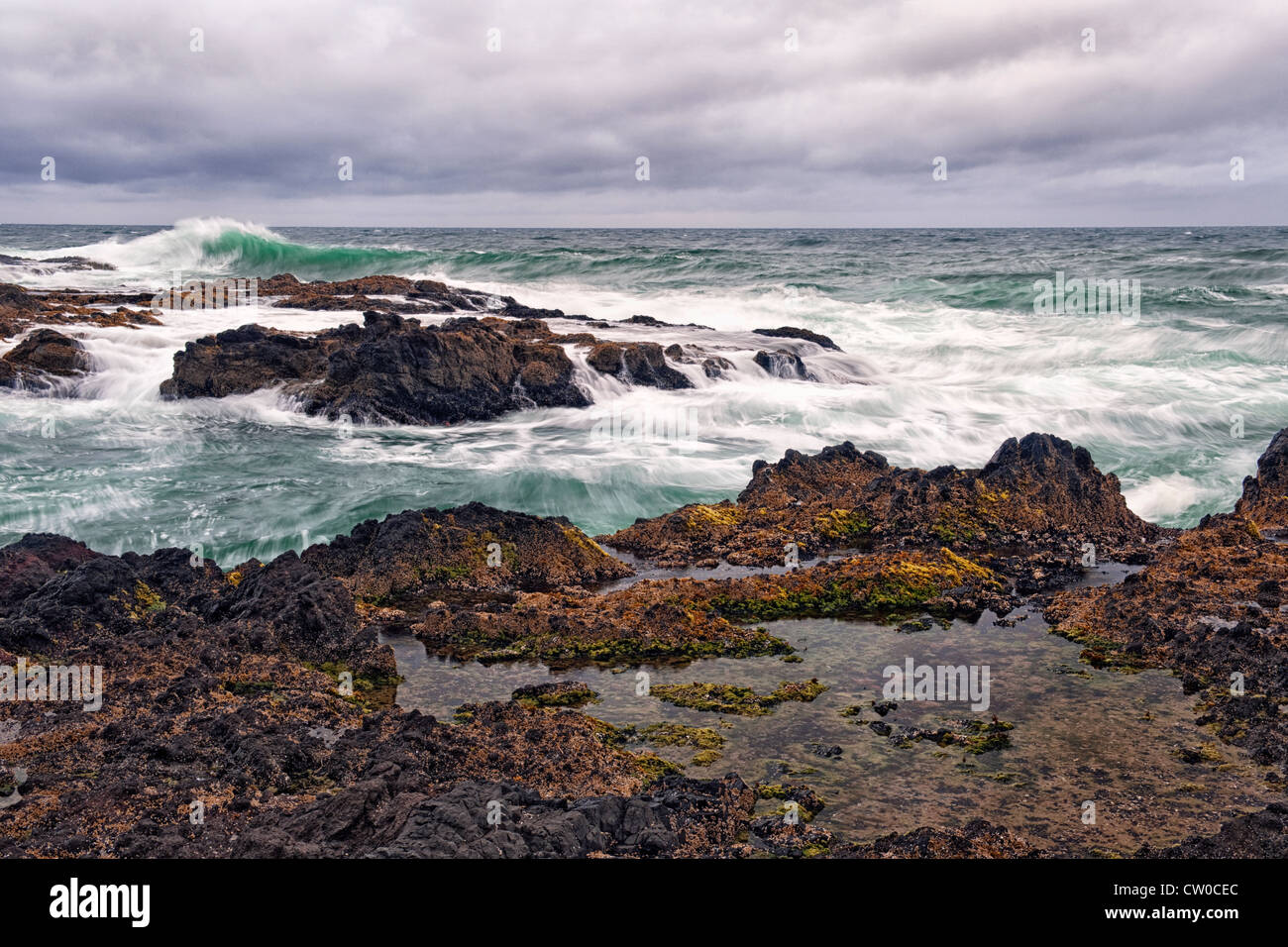 Storm driven waves at high tide race to the basalt shoreline of Oregon ...