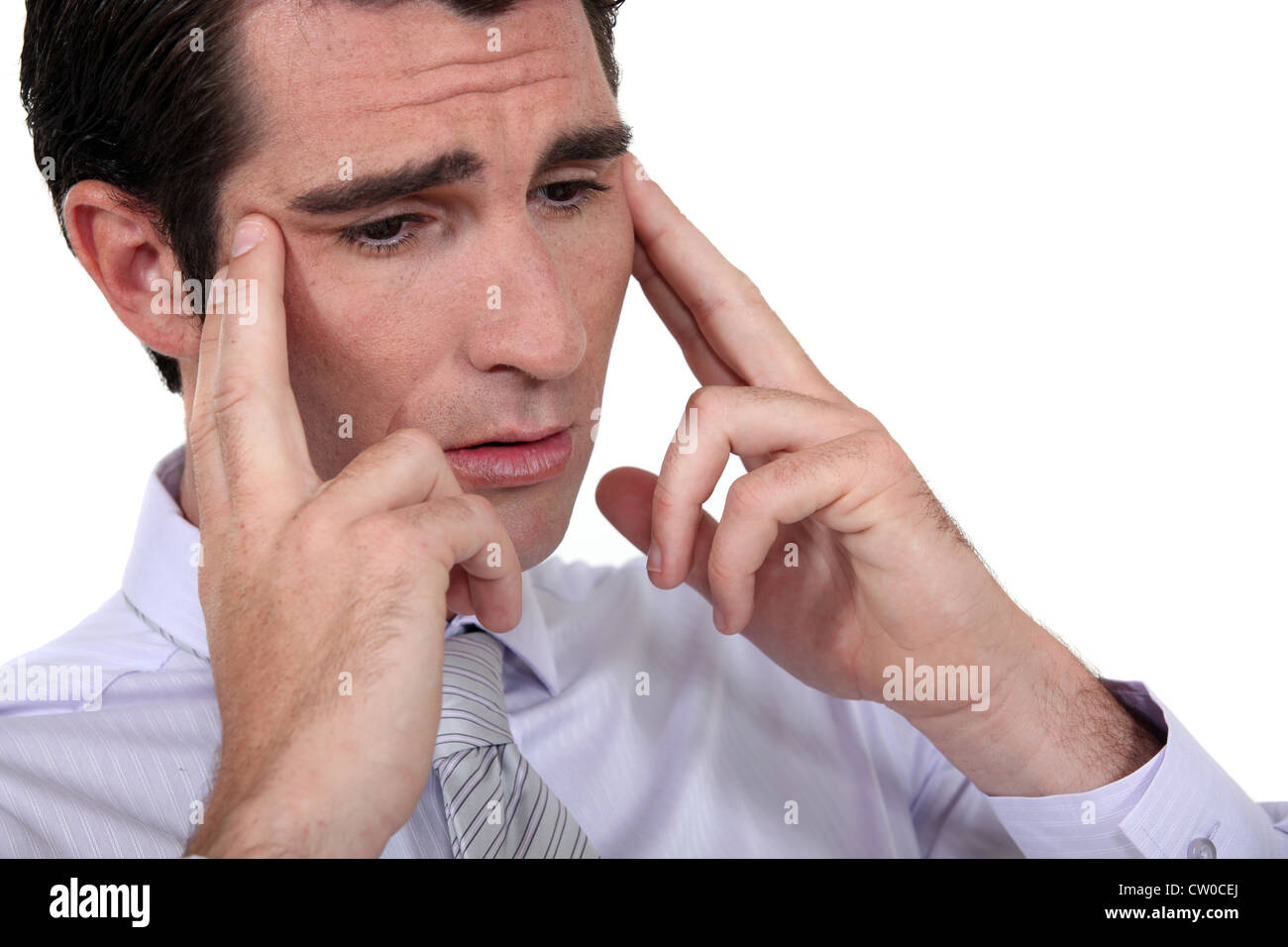 Businessman rubbing his temples Stock Photo - Alamy