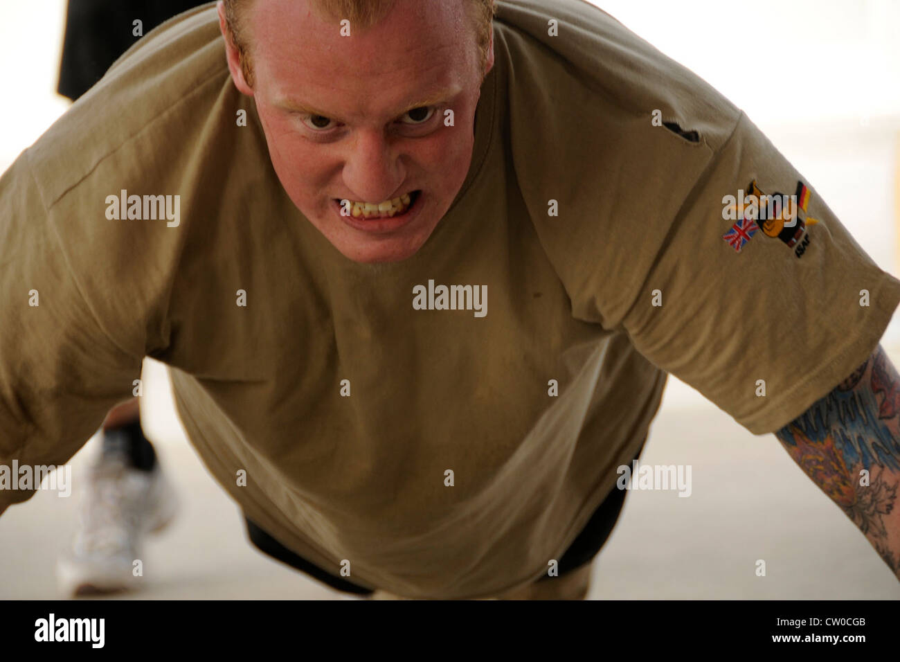 A British Soldier from the KKSG does push-ups during the team push-up ...