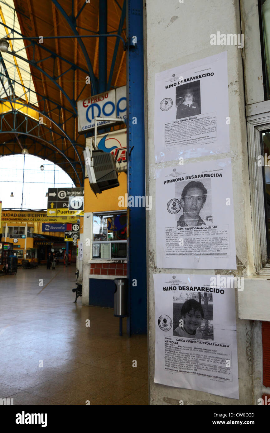 Posters with pictures of missing people and children on wall in main ...