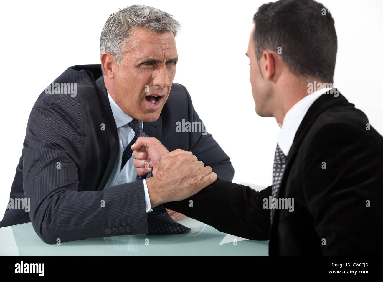 Businessmen fighting at desk Stock Photo - Alamy