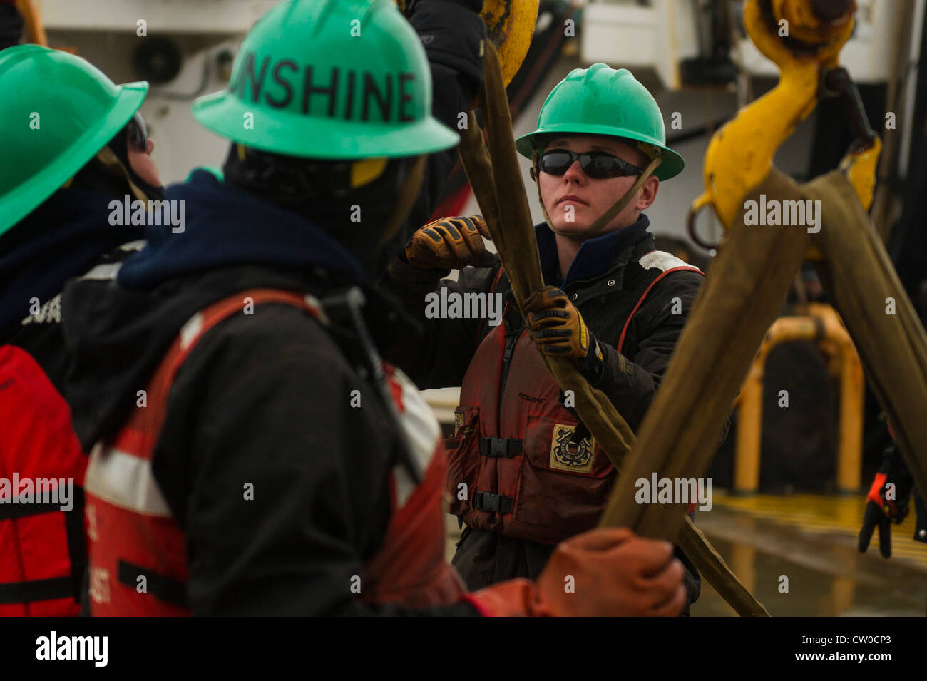 Coast Guard personnel aboard the Coast Guard Cutter Sycamore prepare to ...