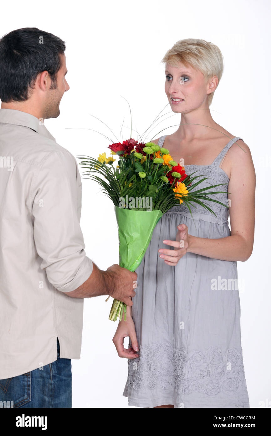 Man giving woman flowers Stock Photo - Alamy