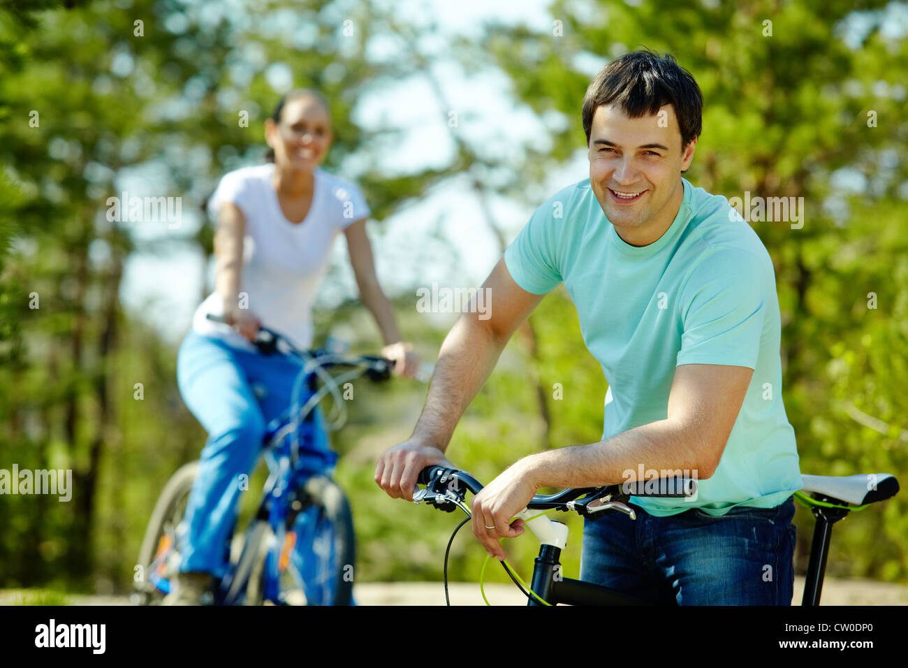 Portrait of a handsome man by his bike Stock Photo - Alamy