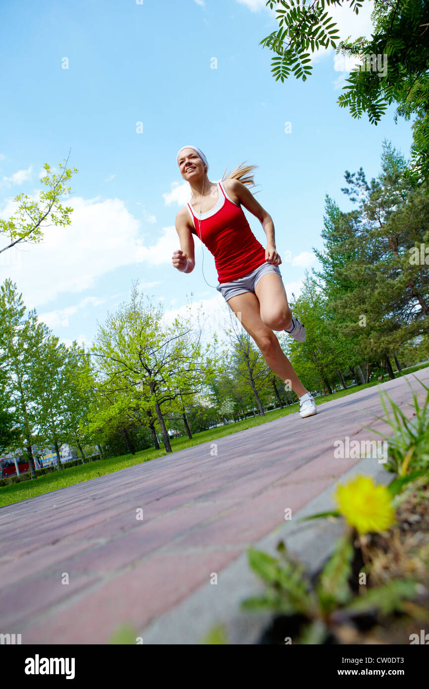A young girl jogging in the park Stock Photo - Alamy