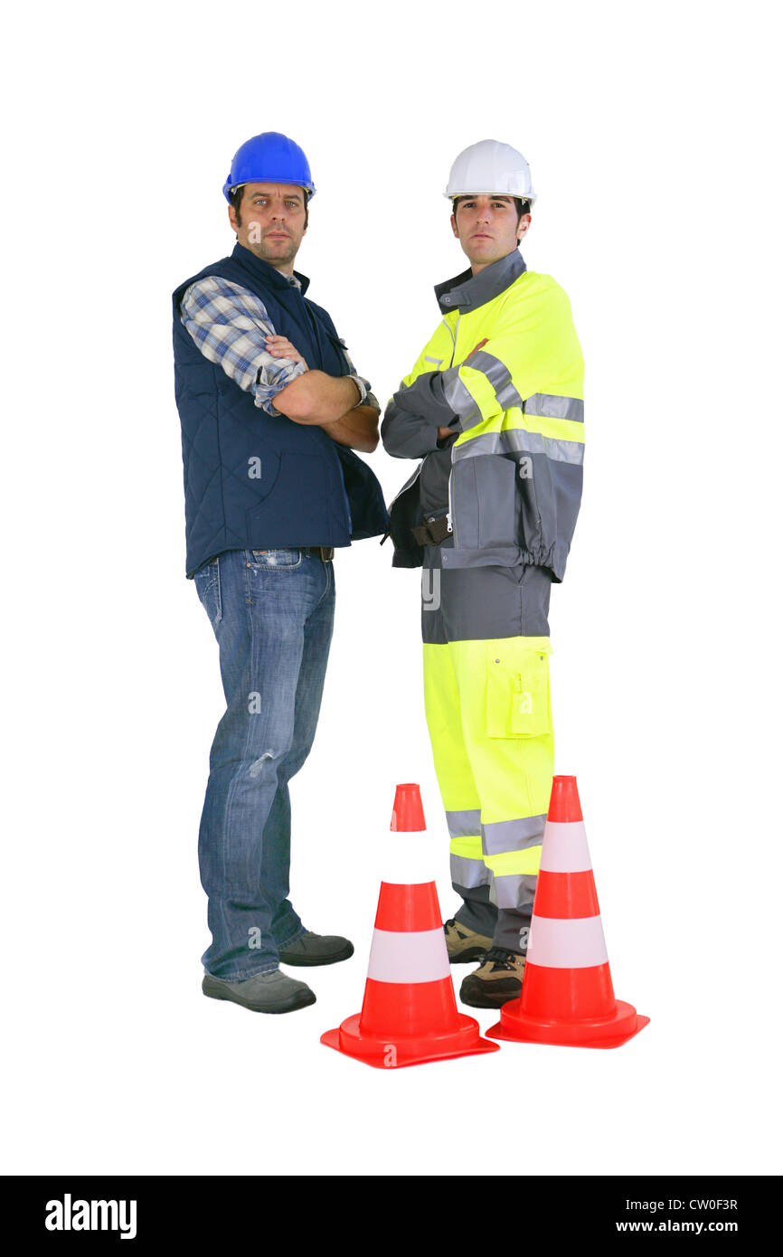 Two road workers stood by traffic cones Stock Photo - Alamy