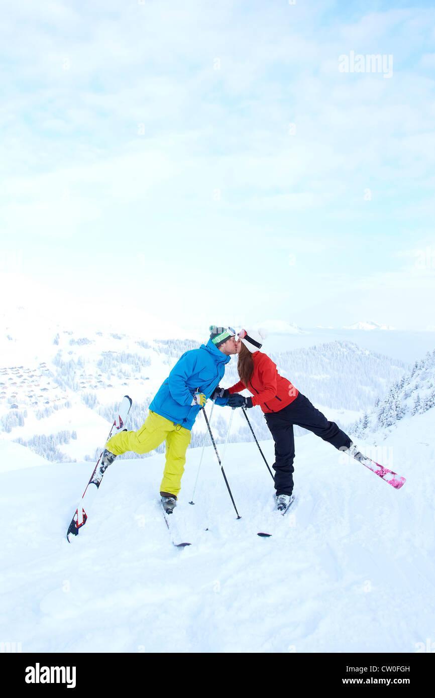 Skiers kissing on snowy mountaintop Stock Photo - Alamy