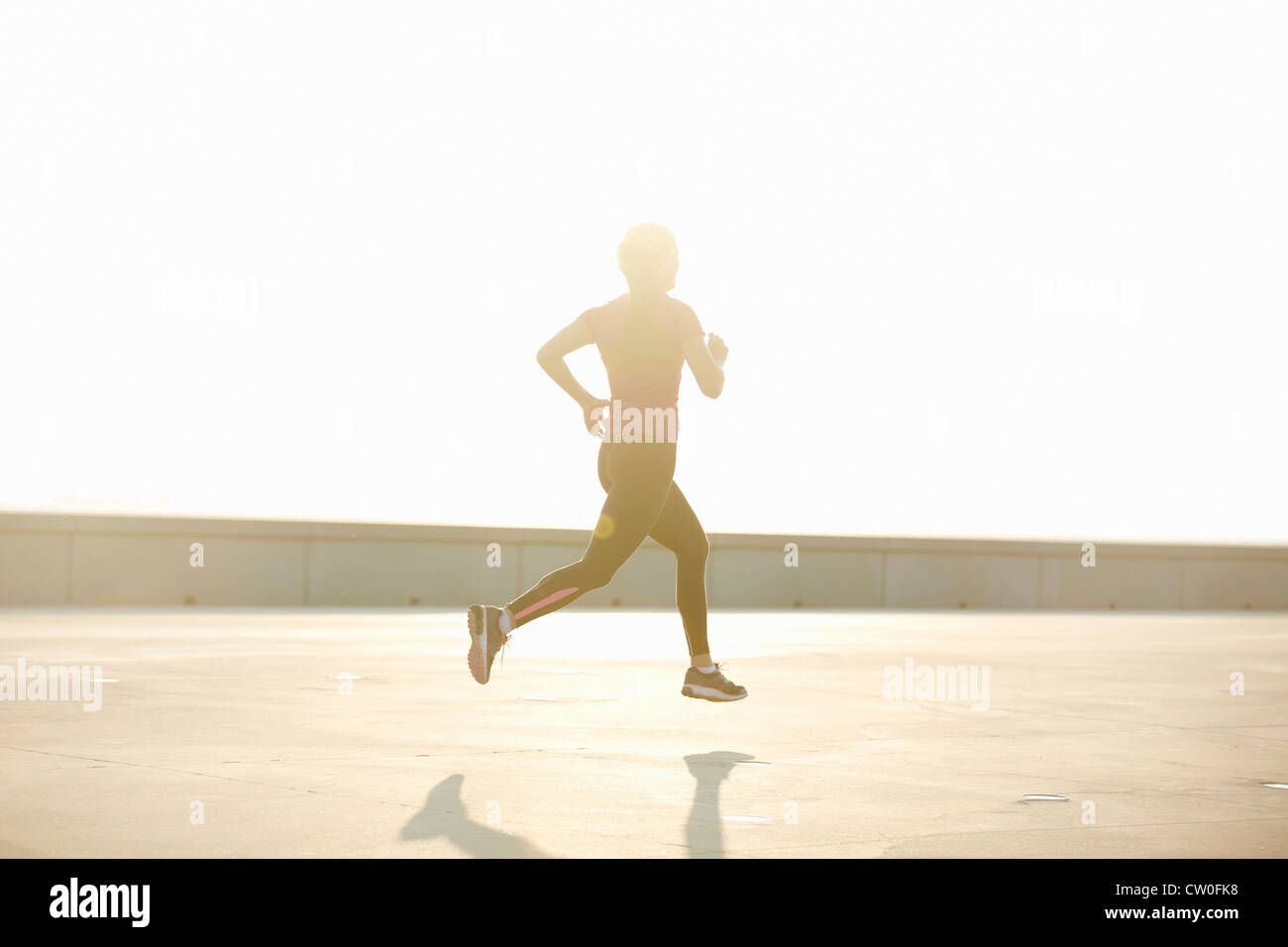 Man running on rooftop Stock Photo - Alamy