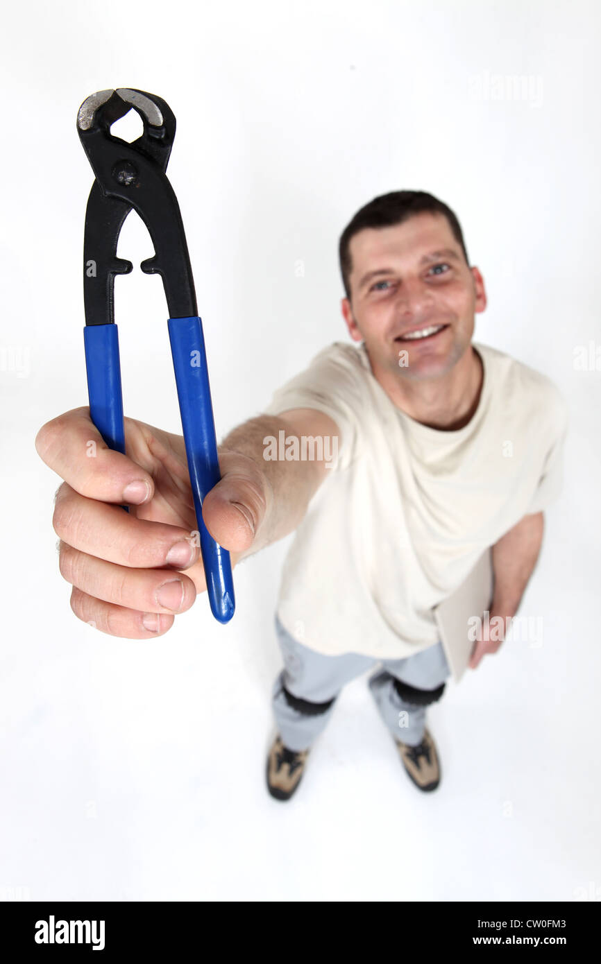 Man with a pair of pliers Stock Photo - Alamy