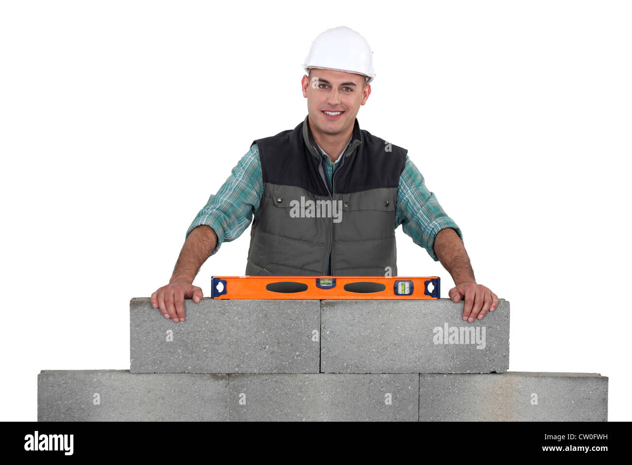 Mason checking level Stock Photo - Alamy