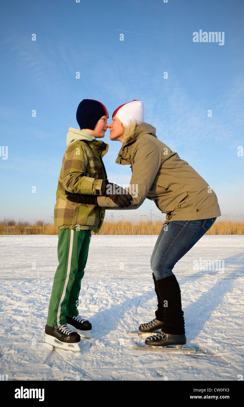 Mother and son touching noses on ice Stock Photo - Alamy
