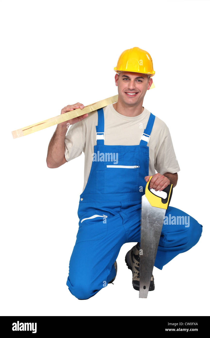 A kneeled carpenter with a handsaw Stock Photo - Alamy