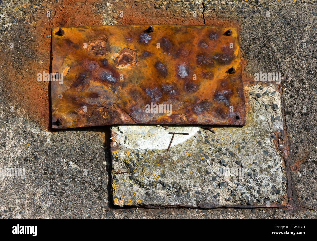 Rusted steel plate & concrete manhole cover Stock Photo - Alamy