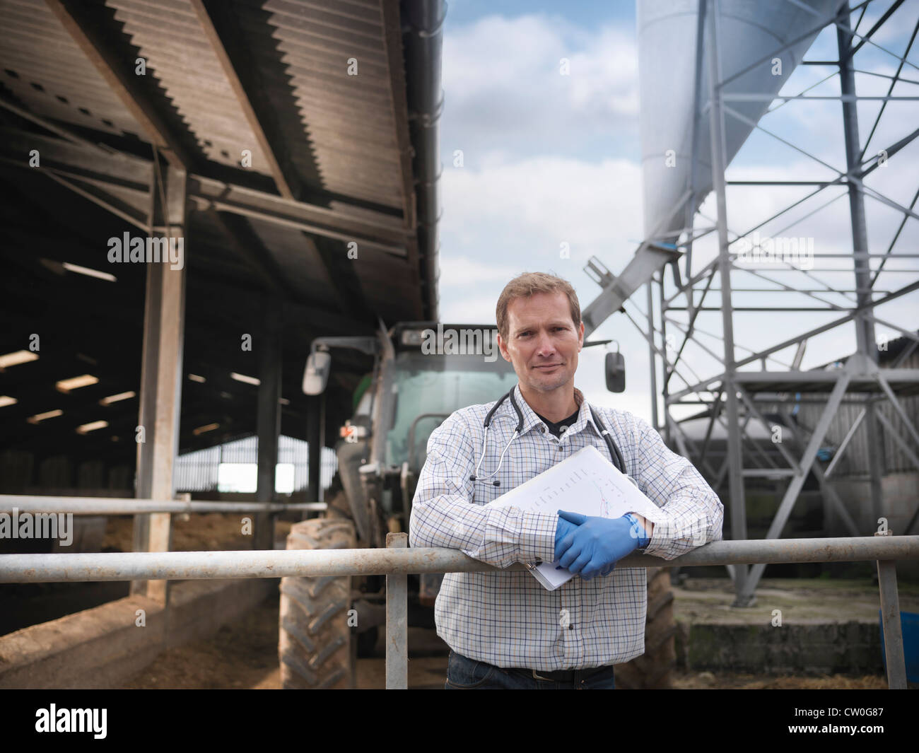 Veterinarian standing outside barn Stock Photo - Alamy