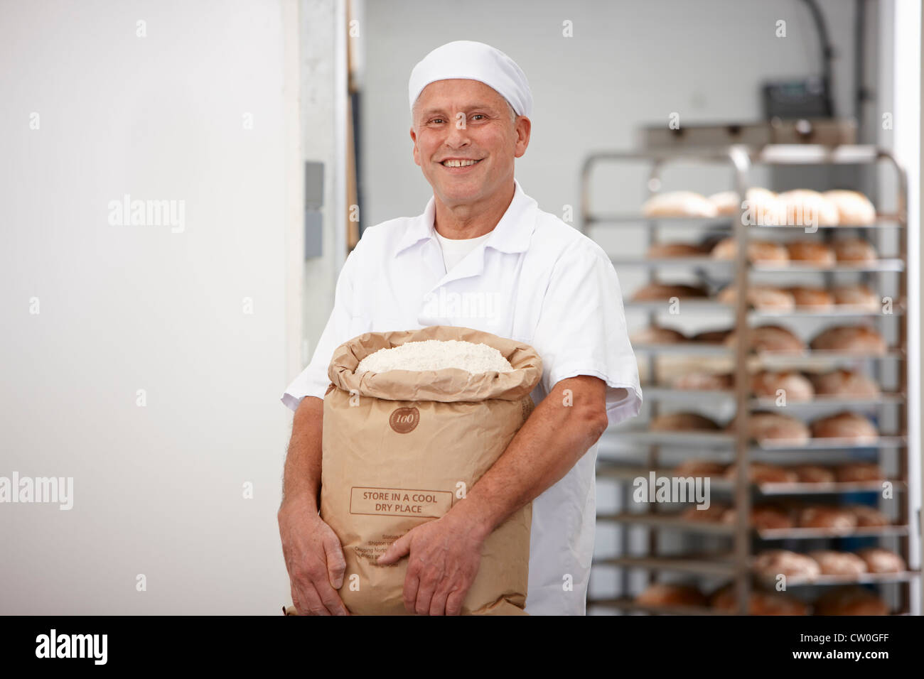Chef carrying sack of flour in kitchen Stock Photo - Alamy