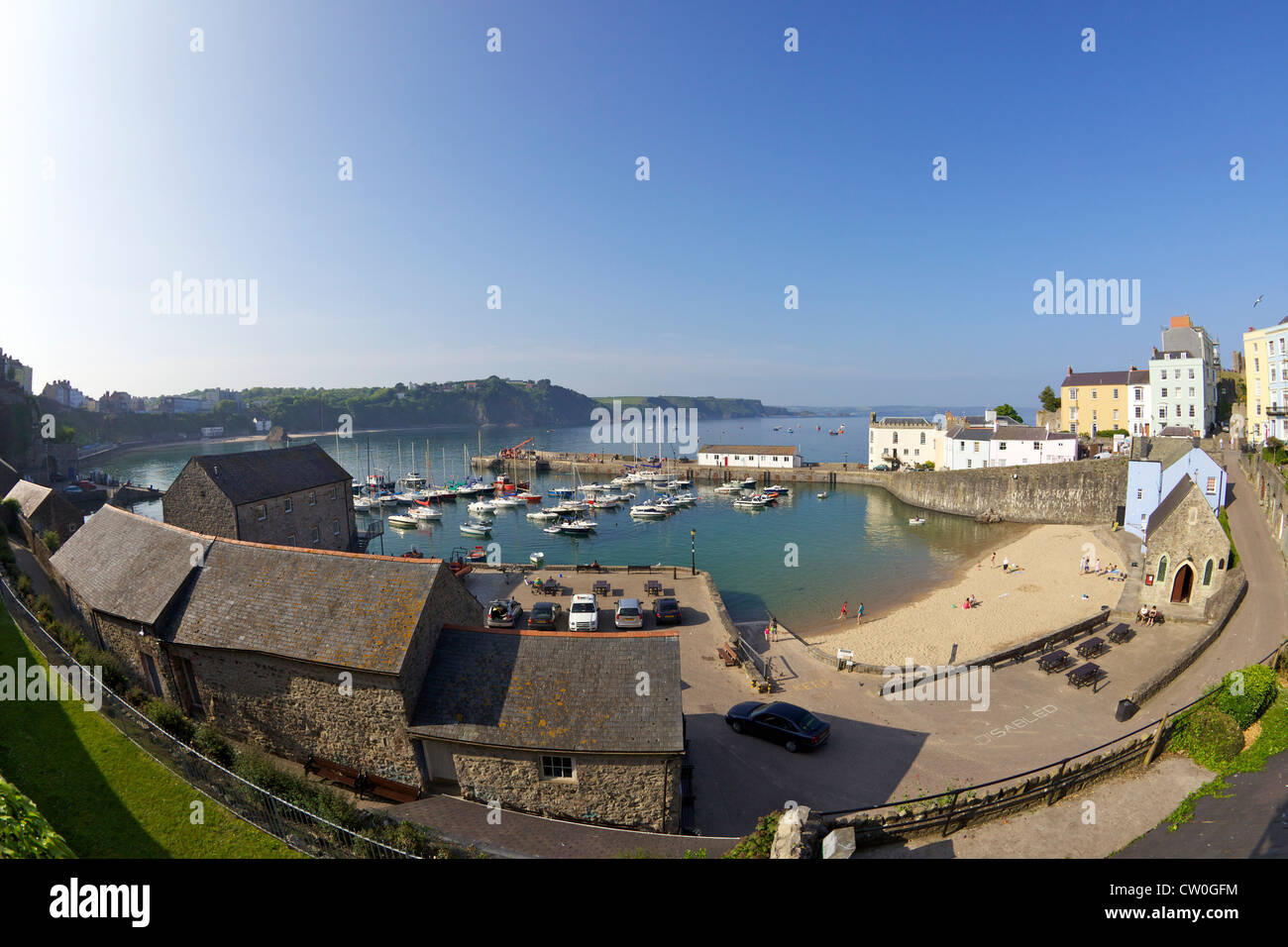 Old historic harbour in evening summer sunshine, Tenby, Pembrokeshire ...