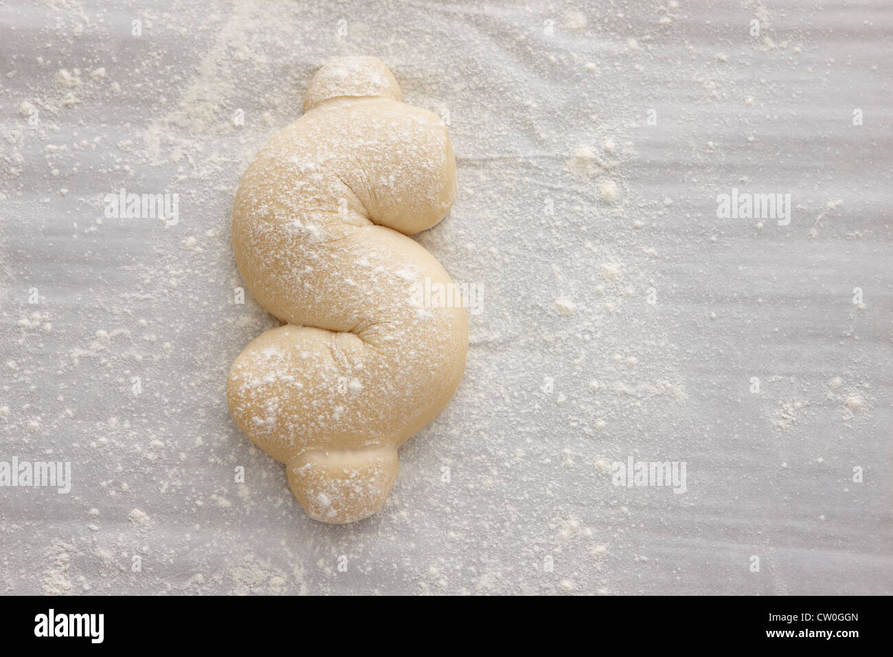 Bread dough shaped in dollar sign Stock Photo - Alamy