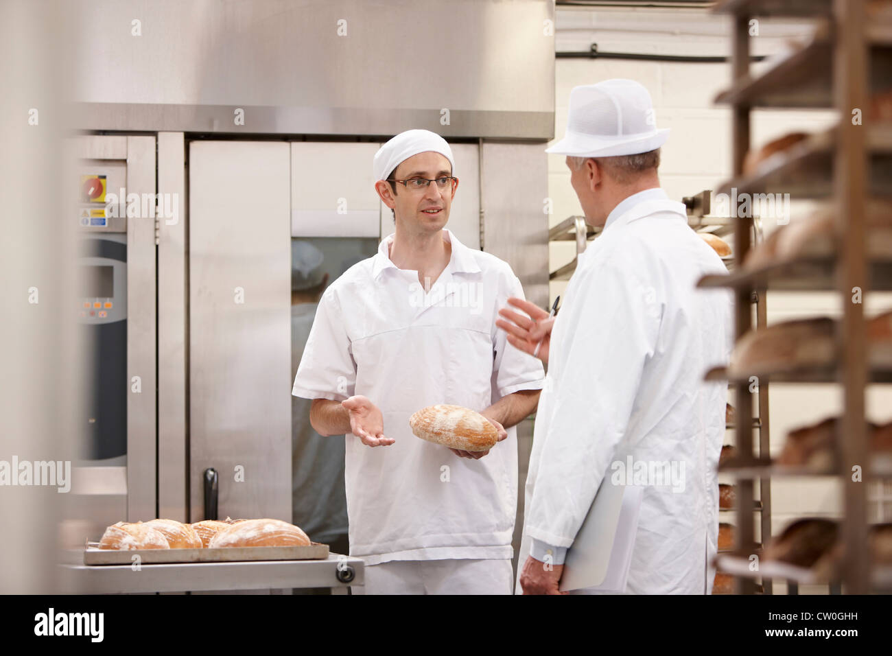 Health inspector with chef in kitchen Stock Photo - Alamy